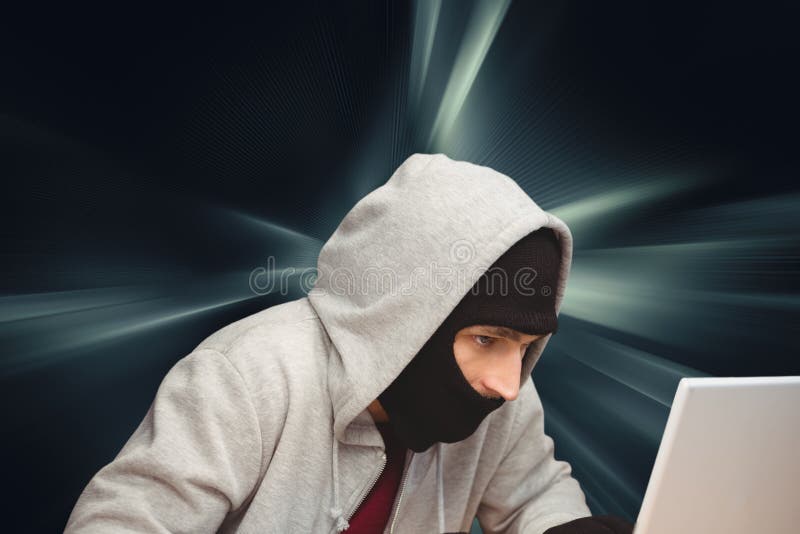 Hacker Hiding His Face and Using a Laptop Against Dark Background Stock ...