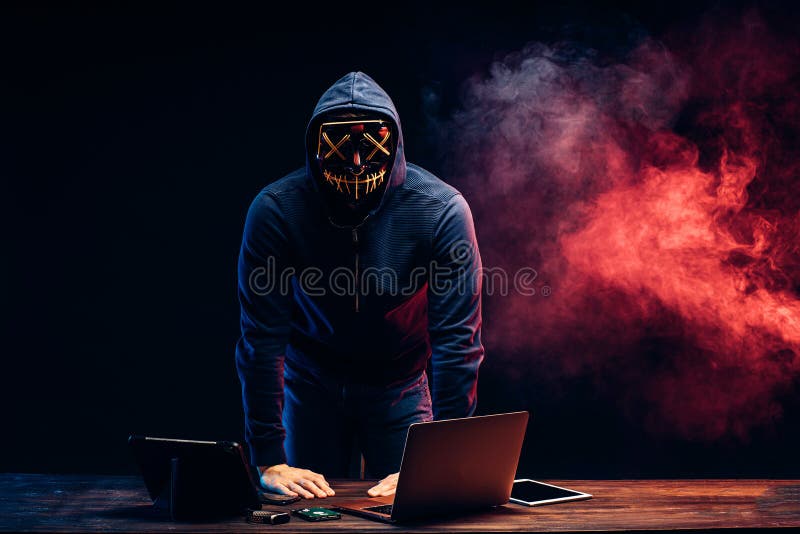 A Hacker in a Hood, a Hacker on a Dark Smoky Background. Stock Image ...