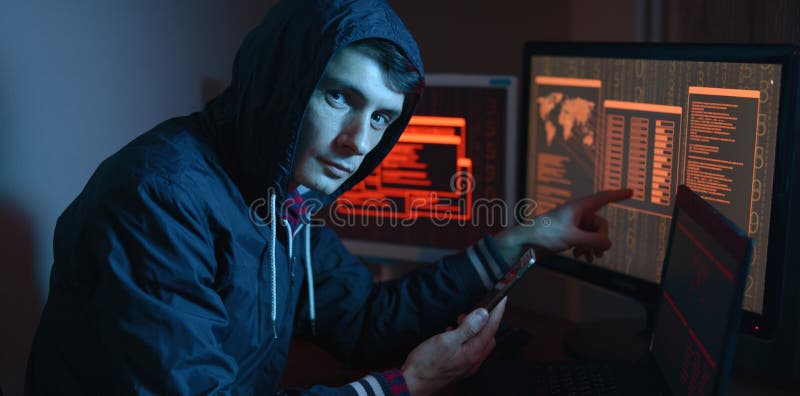 Male in the Hood Looking in the Camera. Hacker Attacks and Online Fraud ...