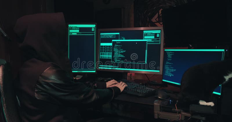 Hacker in a Hood Sits in Front of Computer Screens and Hacks Databases Stock Footage - Video of ...