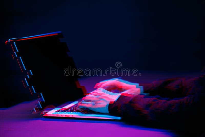 Hacker In The Hood Working With Laptop Typing Text In Dark Room Image