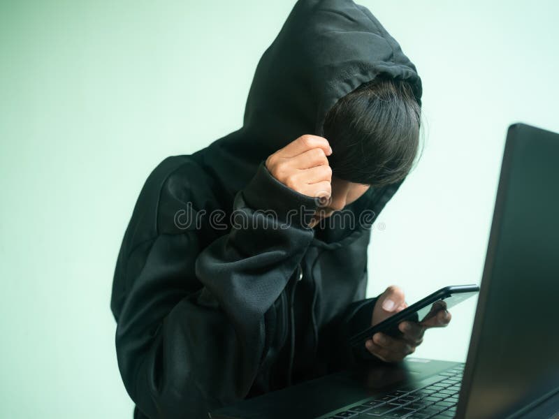 Hacker Hooded Use Mobile Phone with Blur Laptop Computer. Stock Image ...