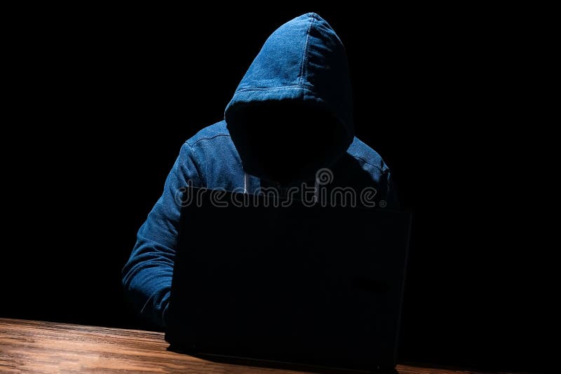 A Hacker with Laptop Sits at a Table and Abstract Binary Code. Business ...
