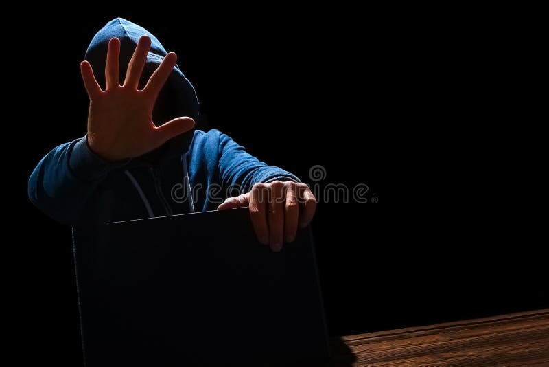 A Hacker with Laptop Sits at a Table and Abstract Binary Code. Business ...