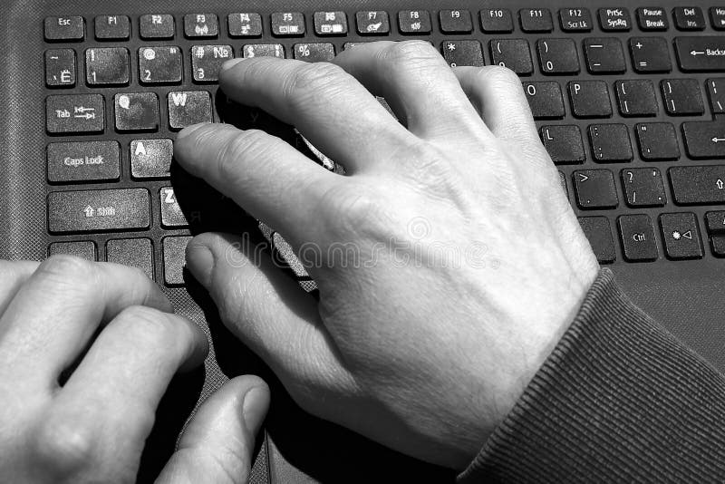 A Hacker with Laptop Sits at a Table and Abstract Binary Code. Business ...