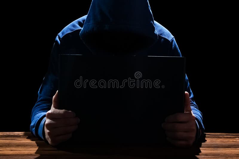 A Hacker with Laptop Sits at a Table and Abstract Binary Code. Business ...