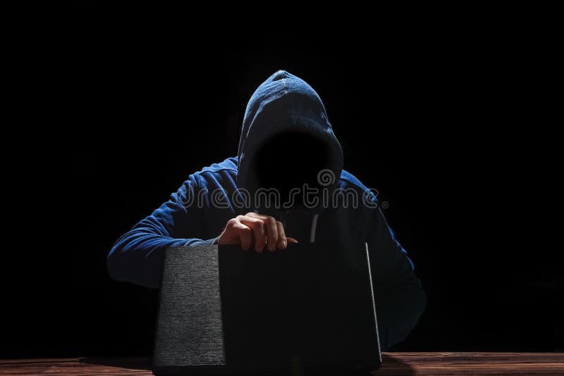 A Hacker with Laptop Sits at a Table and Abstract Binary Code. Business ...