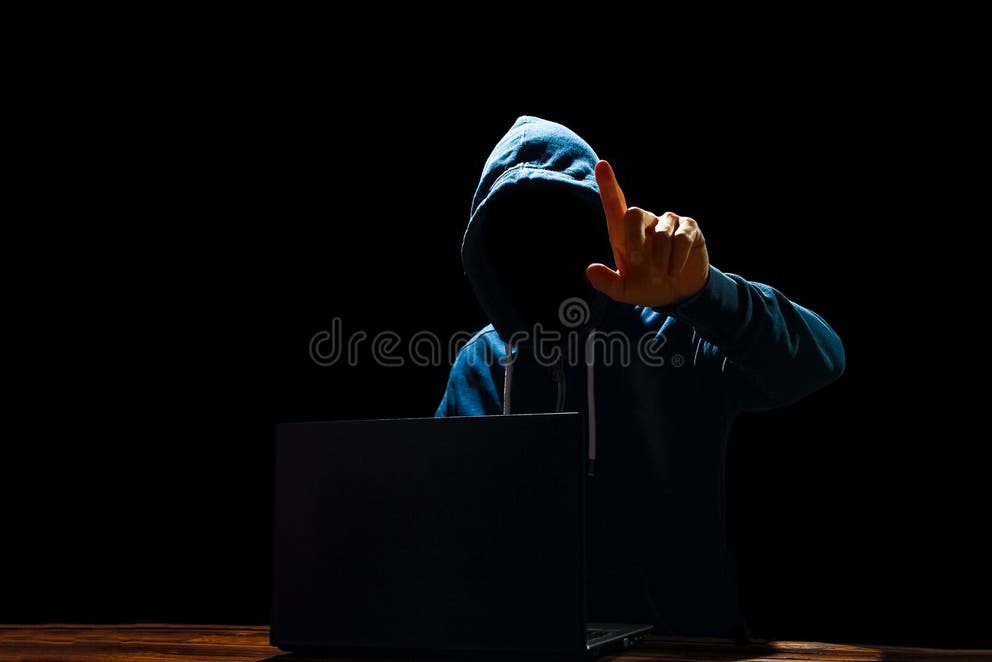 Hacker with Laptop at the Table Breaks into the System Stock Photo ...