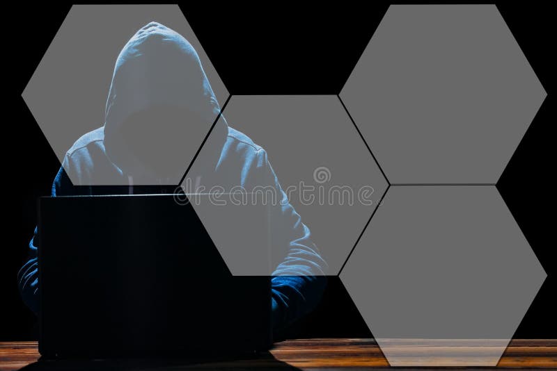 Hacker with Laptop at the Table Breaks into the System Stock Image ...