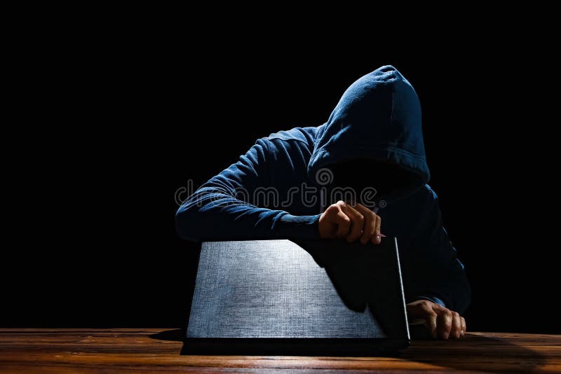 Hacker with Laptop at the Table Breaks into the System Stock Image ...
