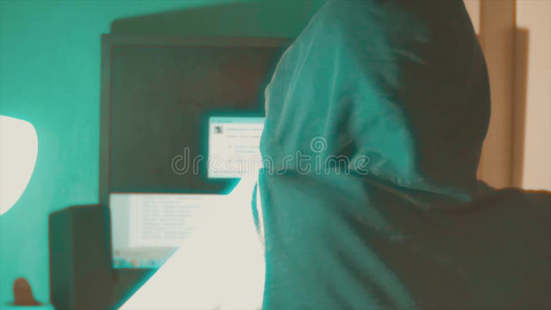 Hacker Man Programmer in the Hood Using Computer for Hack Information and Data from User Account ...