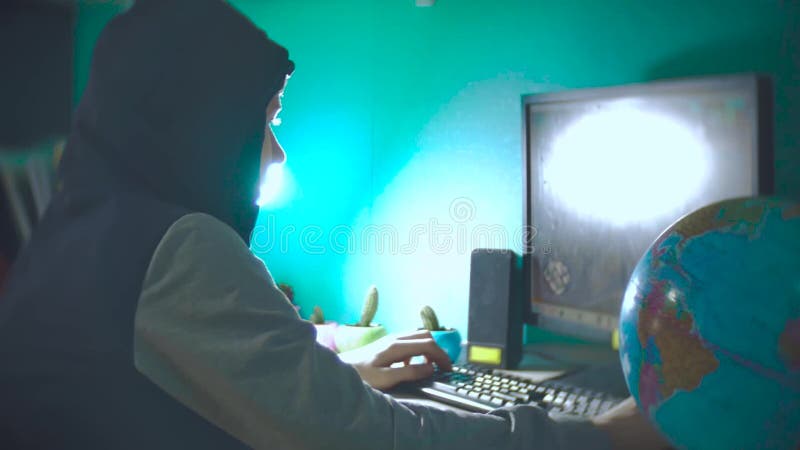 Hacker Man Programmer in the Hood Using Computer Laptop for Hack Information and Data from User ...