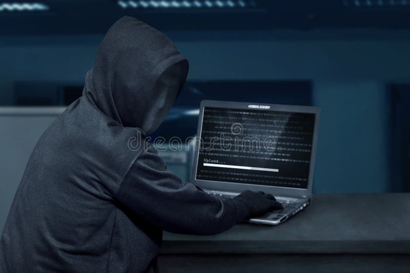 Hacker Man Wearing Mask Using Laptop To Upload Computer Virus Stock ...