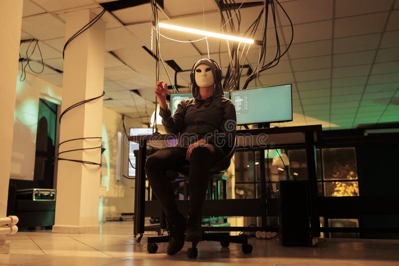 Hacker with Mask Looking at Holographic Image in Augmented Reality ...