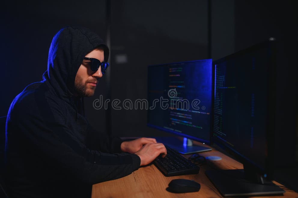 Hacker Sitting at Desk in Dark Atmosphere. a Computer Programmer or Hacker. Anonymous Computer ...