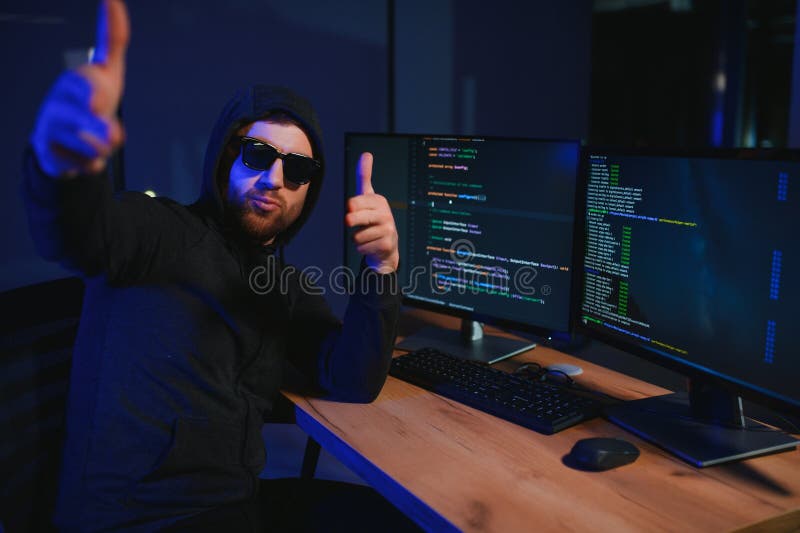 Hacker Sitting at Desk in Dark Atmosphere. a Computer Programmer or Hacker. Anonymous Computer ...