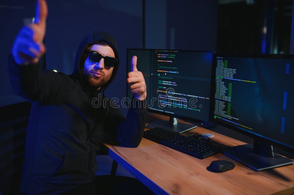 Hacker Sitting at Desk in Dark Atmosphere. a Computer Programmer or ...