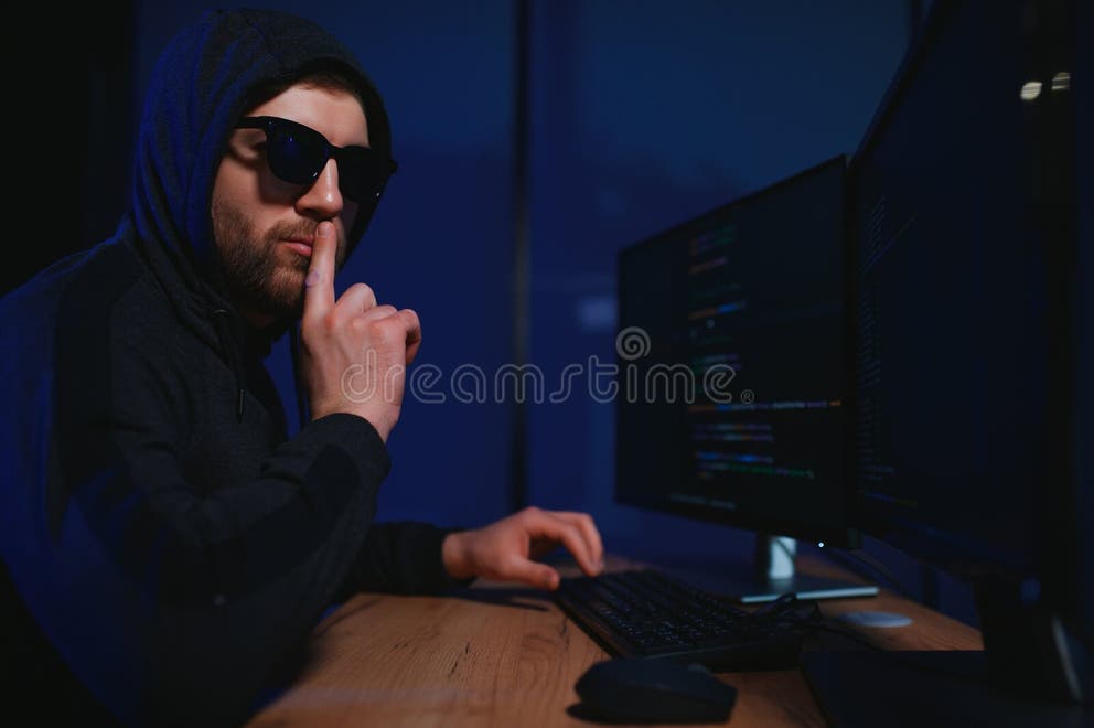 Hacker Sitting at Desk in Dark Atmosphere. a Computer Programmer or Hacker. Anonymous Computer ...