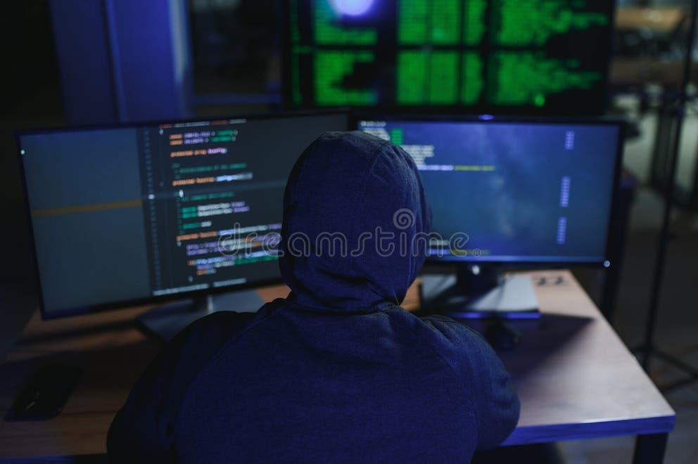Hacker Sitting at Desk in Dark Atmosphere. a Computer Programmer or Hacker. Anonymous Computer ...