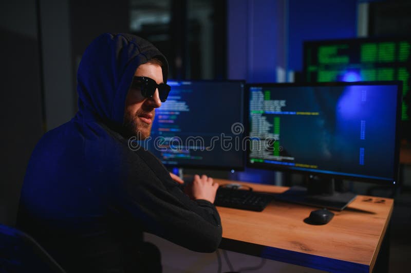 Hacker Sitting at Desk in Dark Atmosphere. a Computer Programmer or Hacker. Anonymous Computer ...