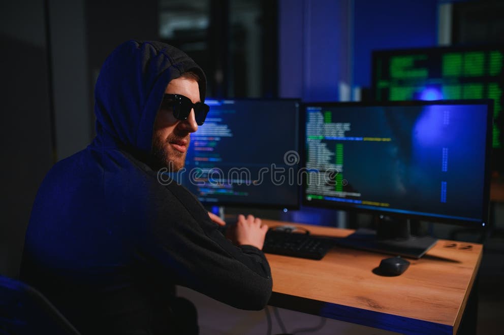 Hacker Sitting at Desk in Dark Atmosphere. a Computer Programmer or Hacker. Anonymous Computer ...