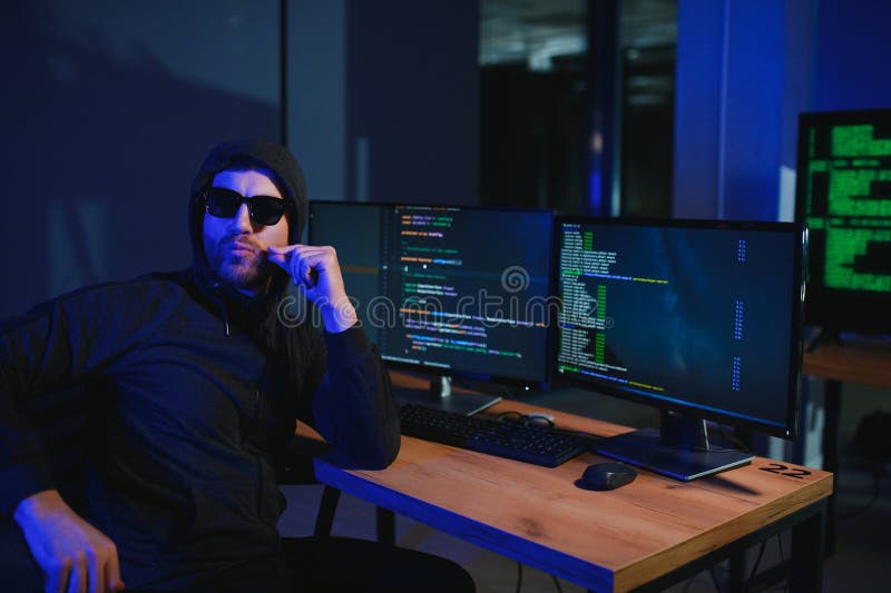 Hacker Sitting At Desk In Dark Atmosphere A Computer Programmer Or Hacker Anonymous Computer