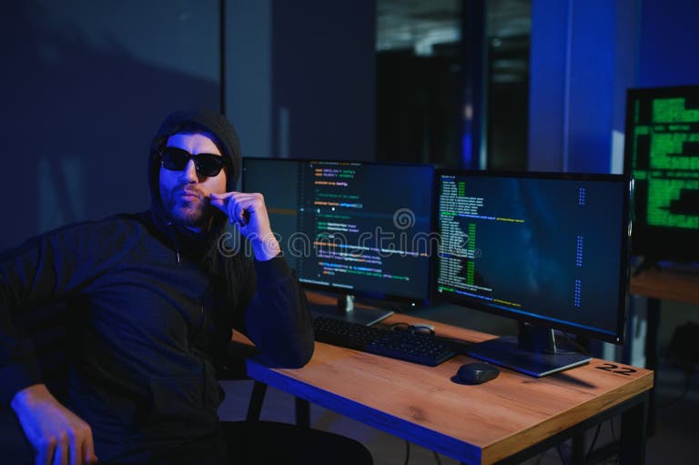 Hacker Sitting at Desk in Dark Atmosphere. a Computer Programmer or Hacker. Anonymous Computer ...