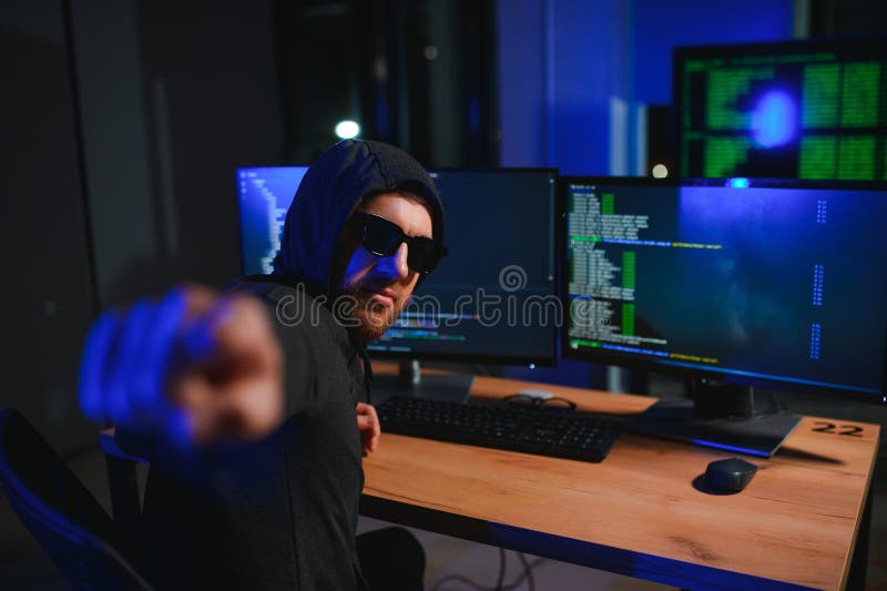 Hacker Sitting At Desk In Dark Atmosphere A Computer Programmer Or Hacker Anonymous Computer
