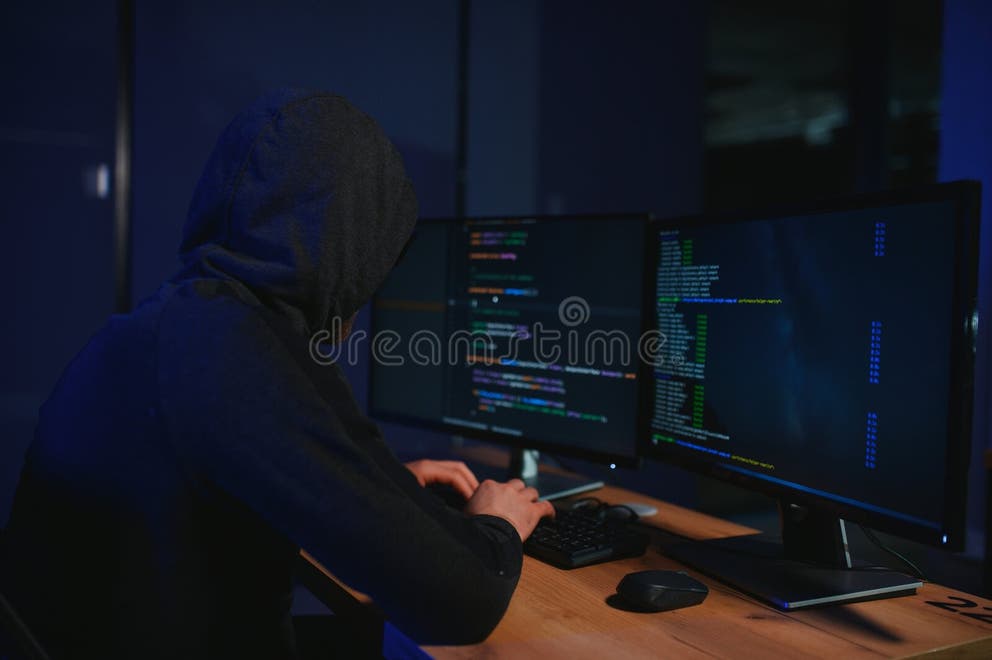 Hacker Sitting at Desk in Dark Atmosphere. a Computer Programmer or Hacker. Anonymous Computer ...