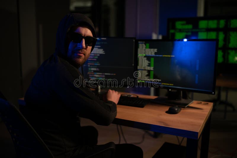 Hacker Sitting At Desk In Dark Atmosphere A Computer Programmer Or Hacker Anonymous Computer