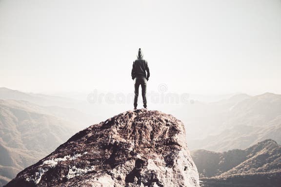 Hacker Staring into the Distance from Top of the Rock Above the Clouds ...