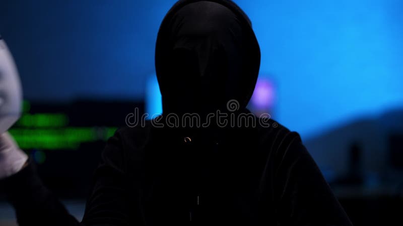 Hacker Taking Off Mask in Blue Room Indoors. Unrecognizable Man in ...