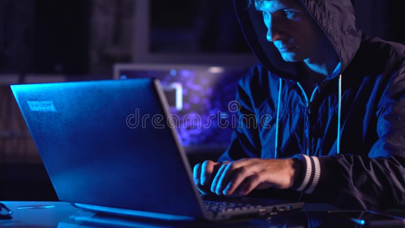 Hacker Typing Program Code While Committing A Cybercrime Hacking A System Firewall In The Dark
