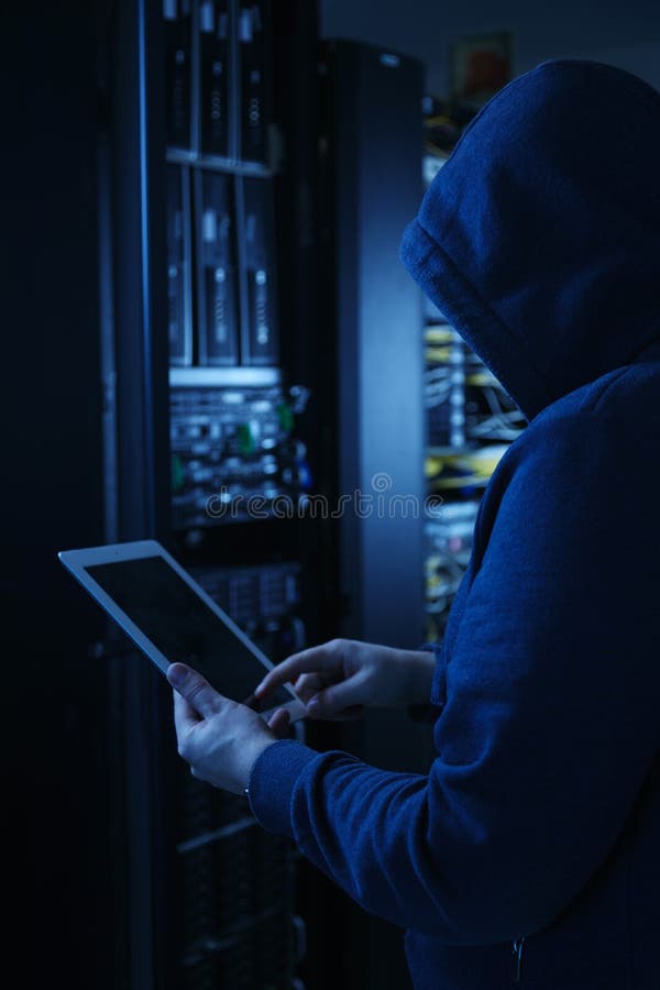 The Hacker Uses a Tablet Computer To Steal Information. Stock Photo ...
