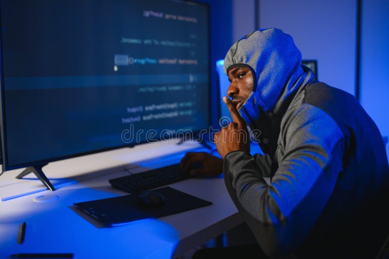 African American Hacker Using Multiple Computers for Stealing Data on Desk Stock Image - Image ...