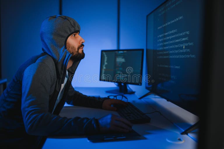 Hacker Using Multiple Computers for Stealing Data on Desk Stock Photo ...