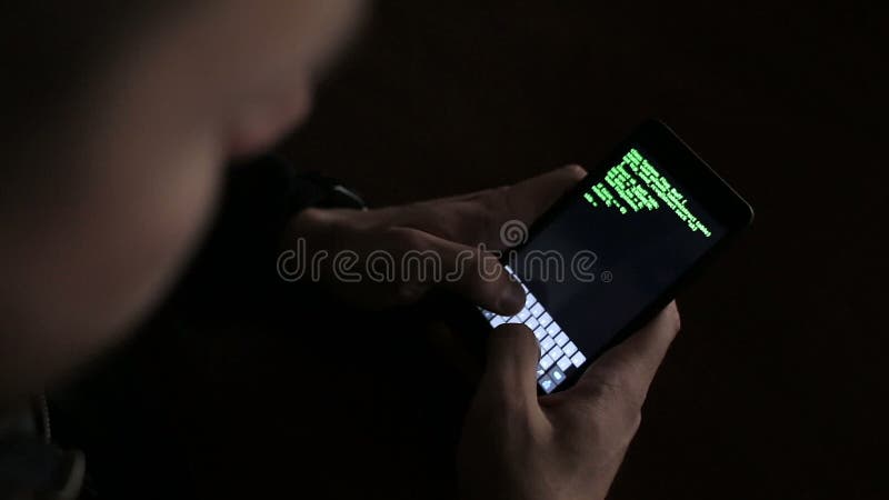 Hacker Using a Smartphone Device To Hijack. Green Code Hacking Text ...