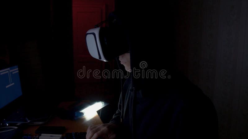Hacker in VR Glasses Cracking Code Using Computers in Dark Room Stock ...
