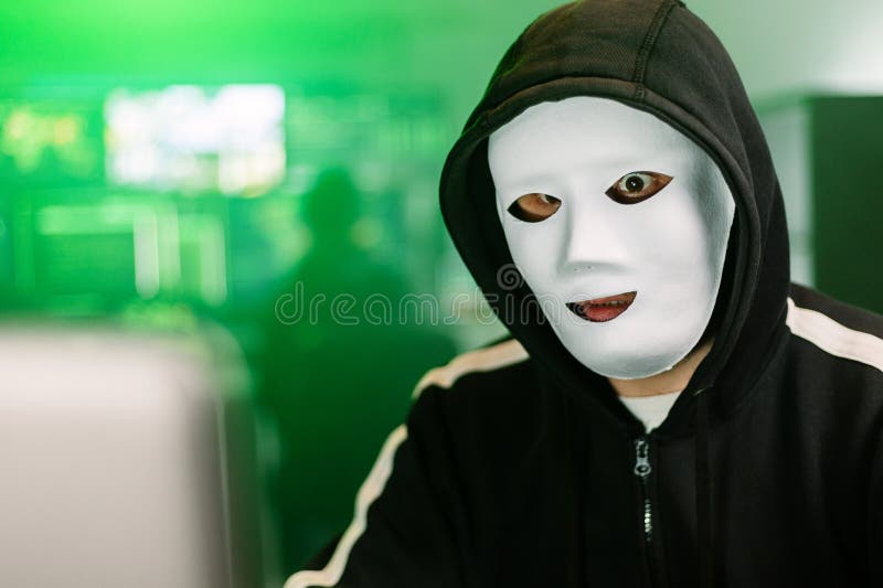 Hacker Working on Laptop in Dark Room with Green Code Displayed on ...