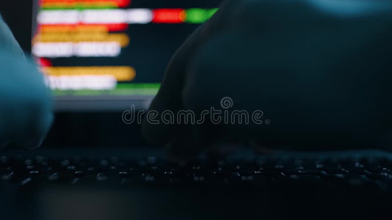 Hacker is Working on Laptop at Night. Hands are Typing a Virus Code at ...