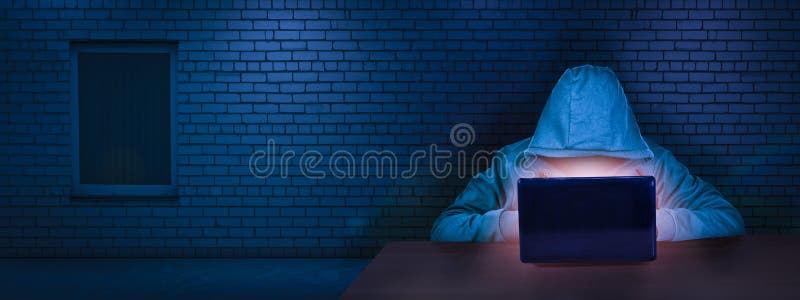 The Hacker Works Behind a Laptop Screen in a Room with a Brick Wall ...