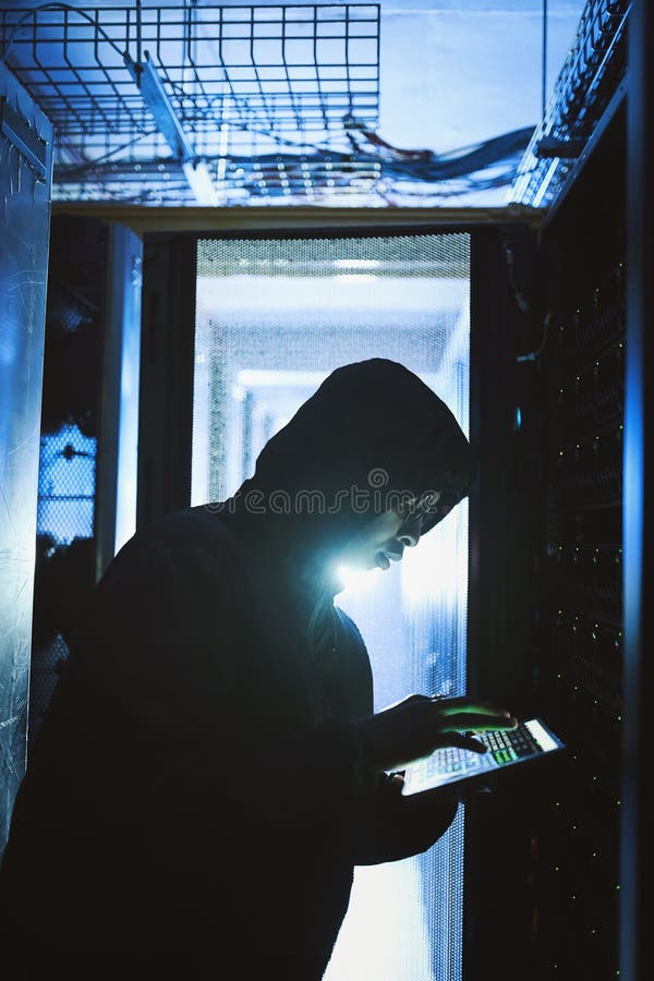 Hacking into Your Mainframe. a Hacker Using a Digital Tablet in a ...