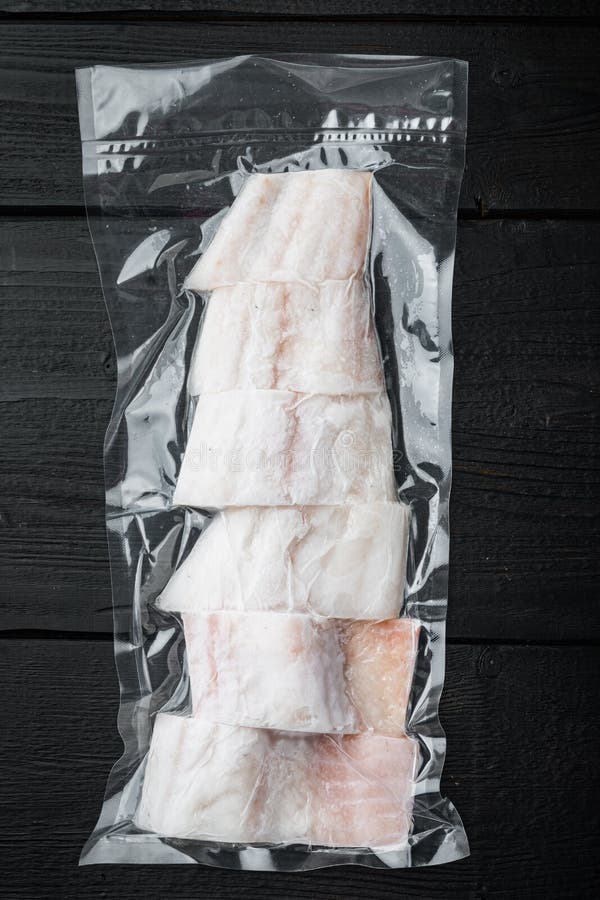 Haddock Fish Skinless in Vacuum Pack, on Black Wooden Table Stock Image ...