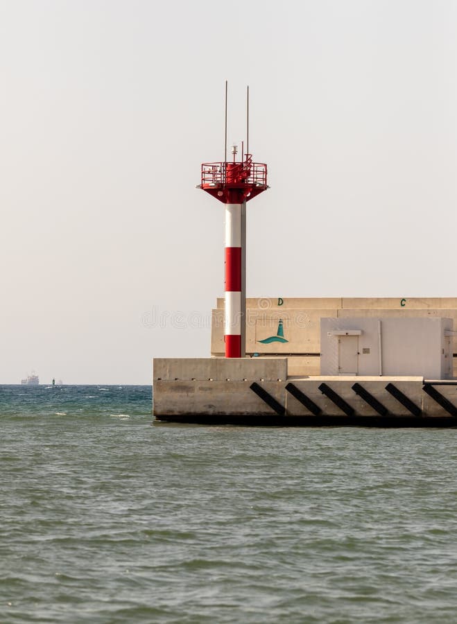 A Small Lighthouse is Located on the Breakwater at the Exit from the ...