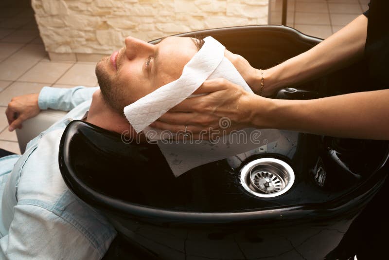 Hair Salon Master Washing Client Hair At Barber Shop Male Client