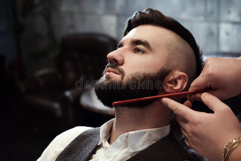 Hairdresser Man Shaves a Client with a Beard in a Barbershop Stock ... Hairdresser Man Shaves a Client with a Beard in a Barbershop Stock ...