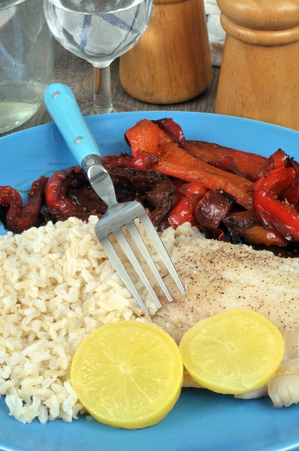 Hake Plate with Rice and Peppers Served at the Table Stock Photo ...