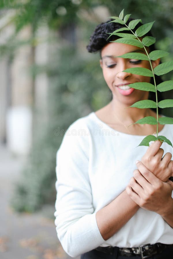 Half American Nigerian Young Woman With Bangs Standing With Green Leaf ... Half American Nigerian Young Woman With Bangs Standing With Green Leaf ...
