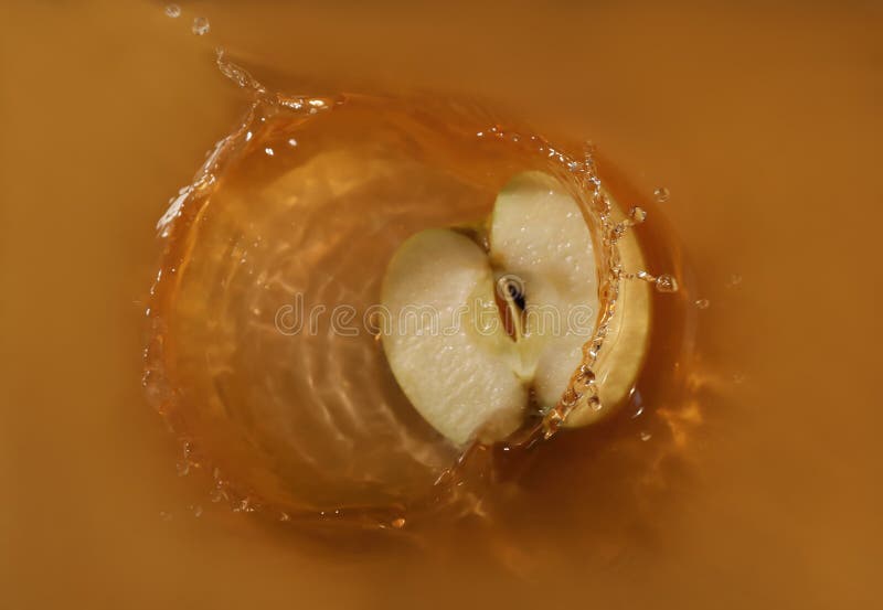 Half of Apple Falling in Juice with Splash, Top View Stock Photo ...