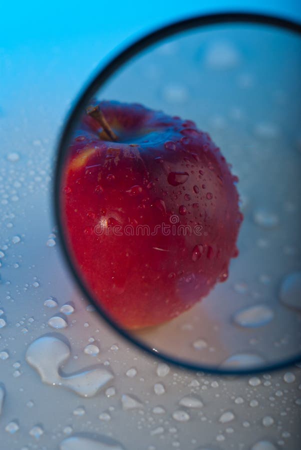 Half Apple Under Magnifying Glass Stock Photo - Image of loupe, drops ...